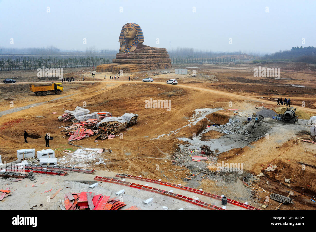Visitors walk past the replica of the Great Sphinx at the construction ...