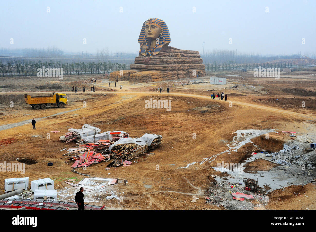 Visitors walk past the replica of the Great Sphinx at the construction ...
