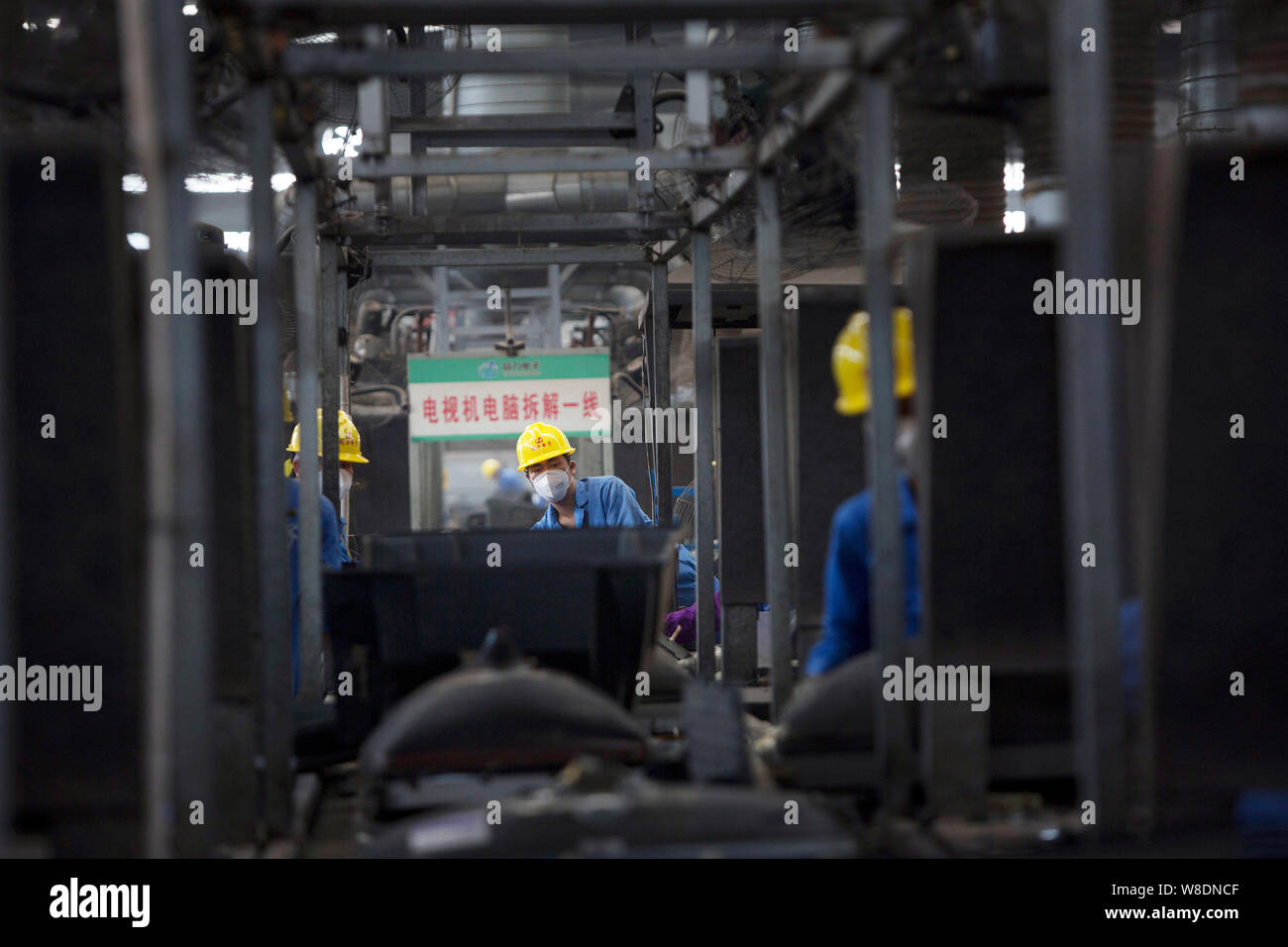 Chinese workers disassemble tube television sets in a plant at the ...