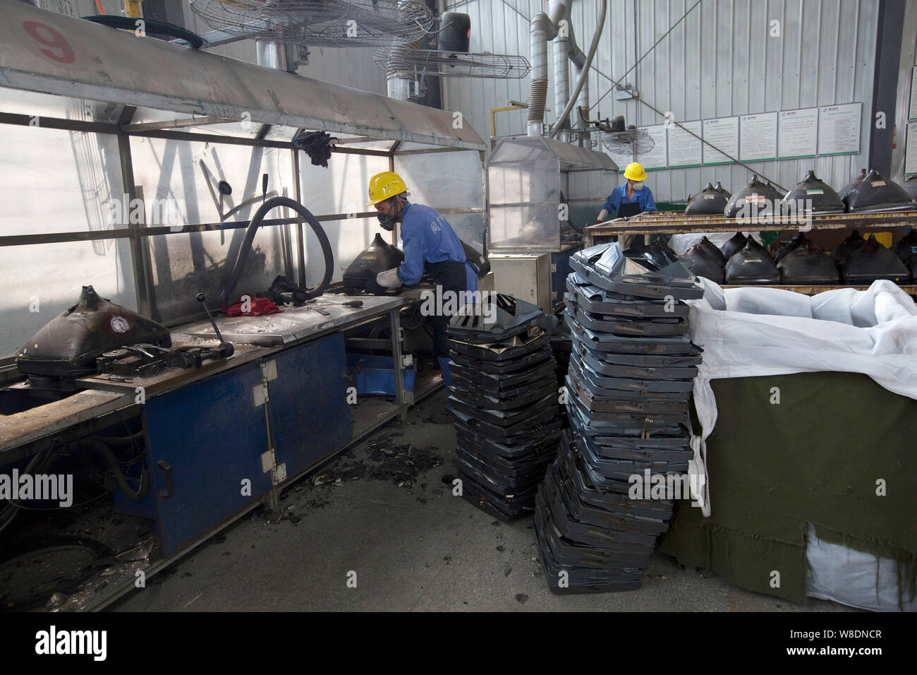 Chinese workers disassemble tube television sets in a plant at the ...