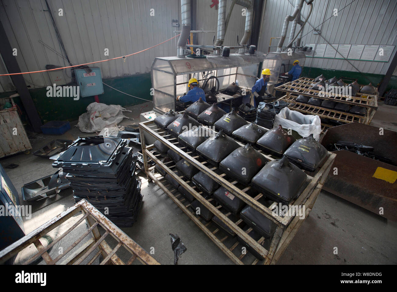 Chinese workers disassemble tube television sets in a plant at the ...
