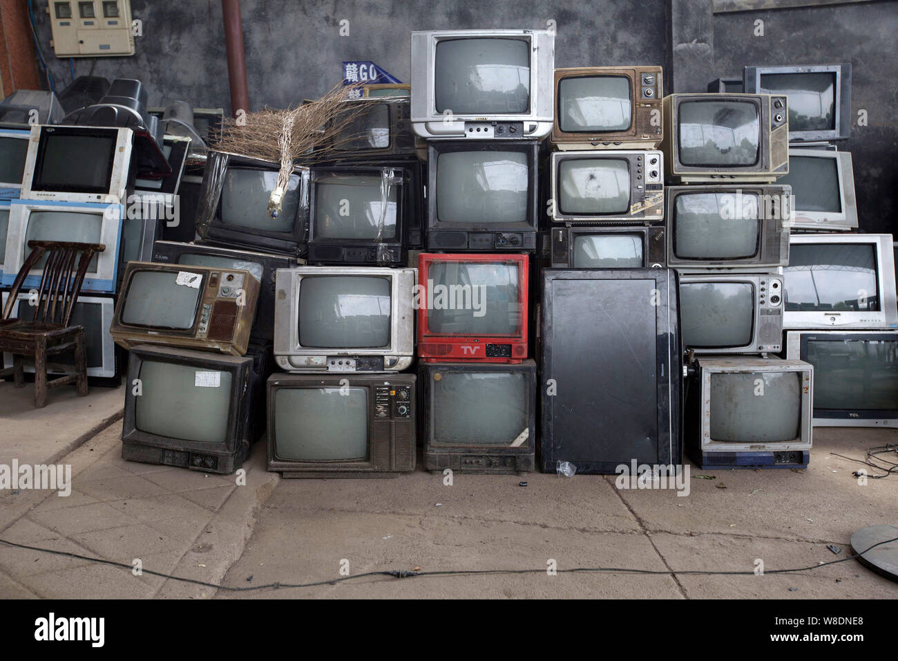 Tube television sets to be disassembled pile up in a plant at the Miluo ...