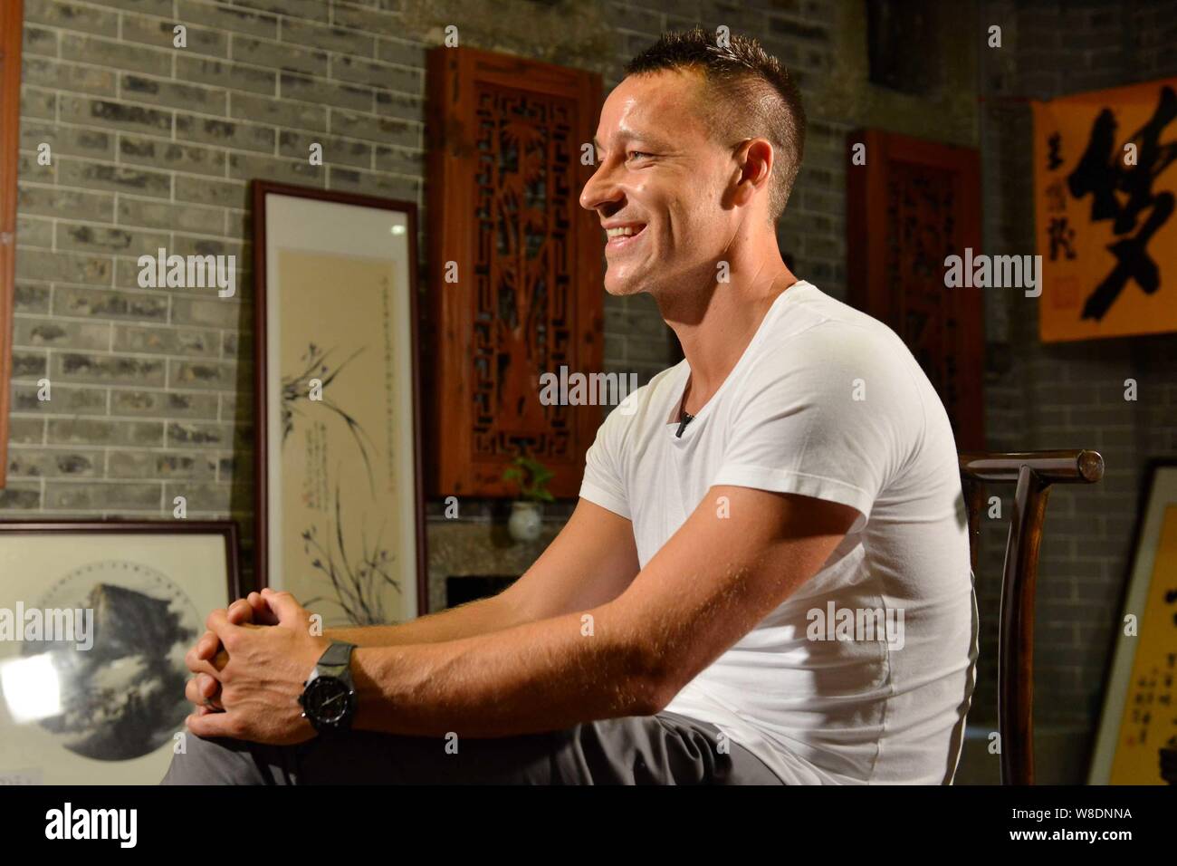 English soccer player John Terry smiles during an interview at the ...