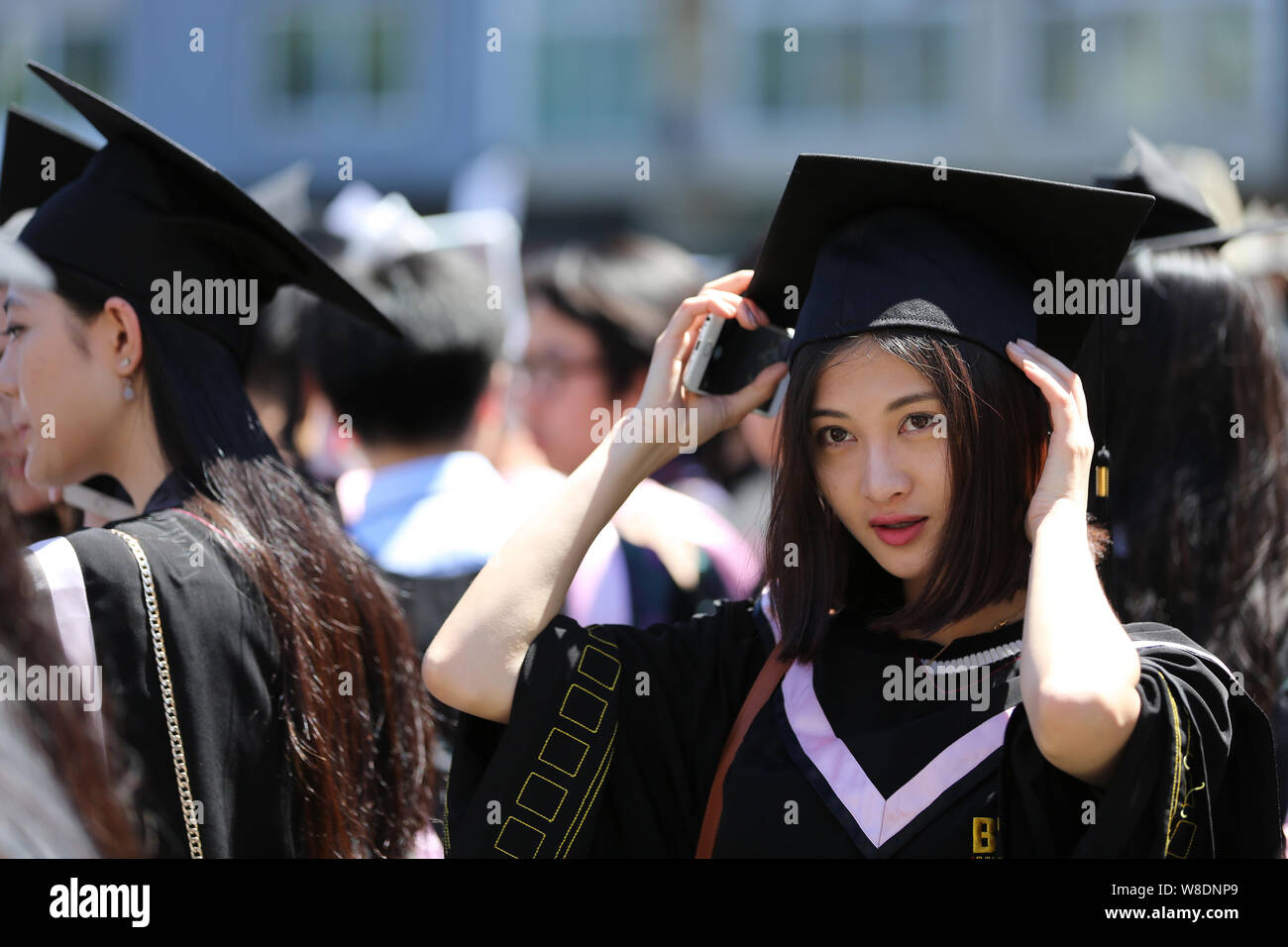 Female Chinese graduates take part in a graduation ceremony at Beijing ...