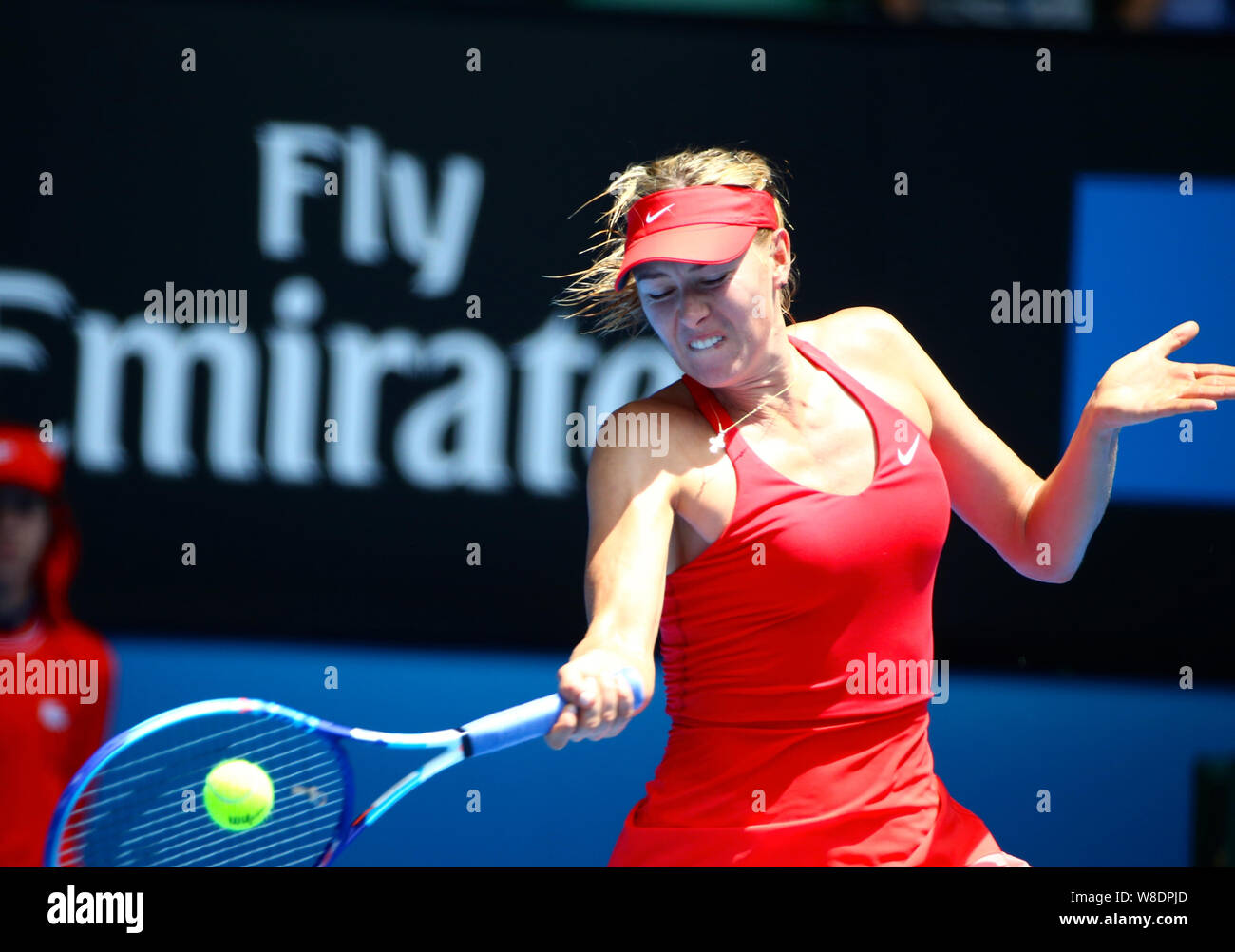 Maria Sharapova of Russia returns a shot to Alexandra Panova of Russia ...