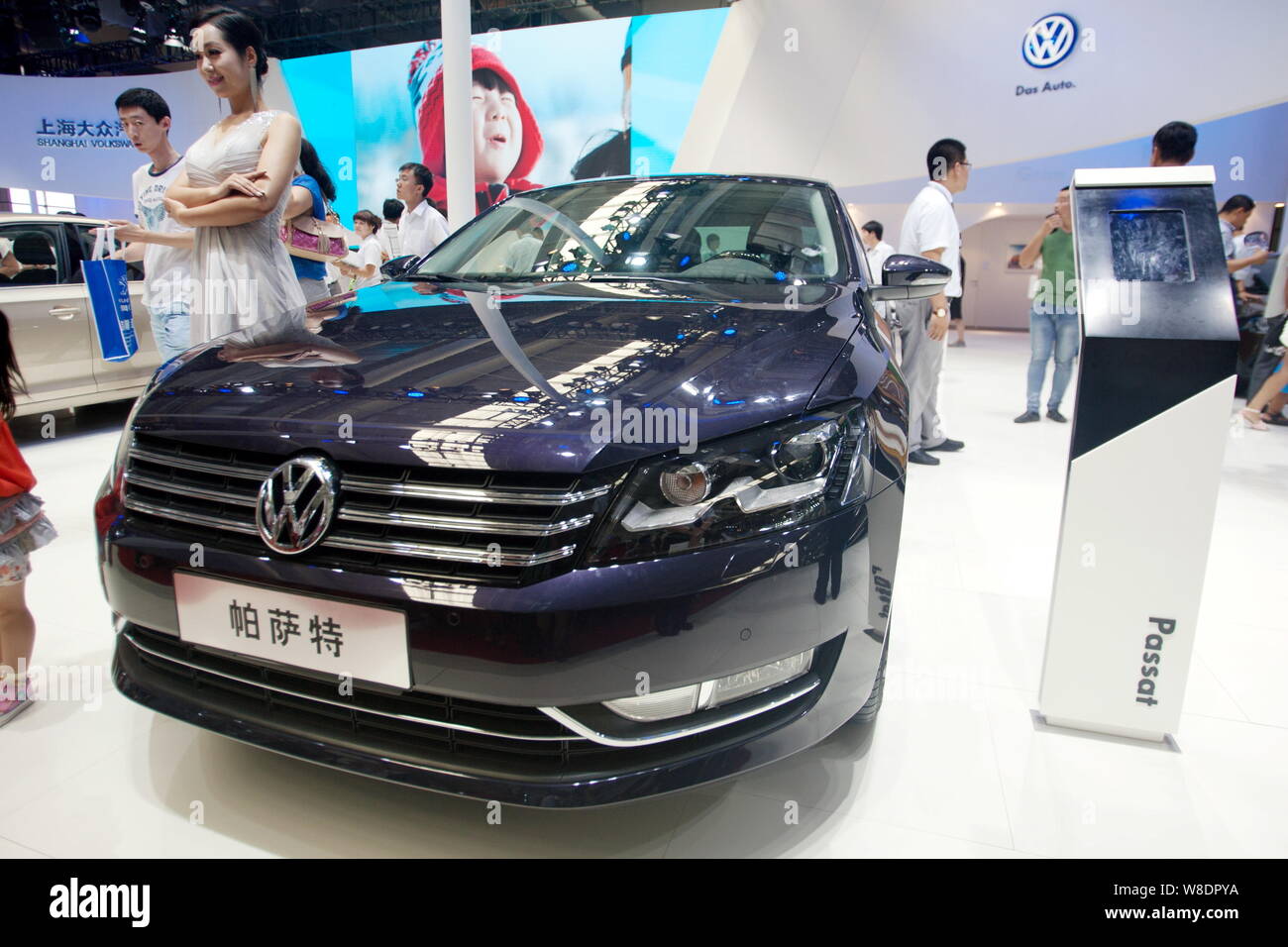 --FILE--Visitors look at Passat and other cars of Shanghai Volkswagen ...