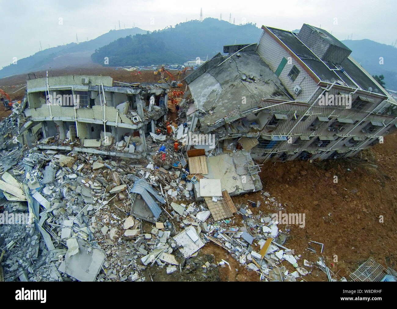 In this aerial view from a drone, Chinese rescuers search for survivors ...