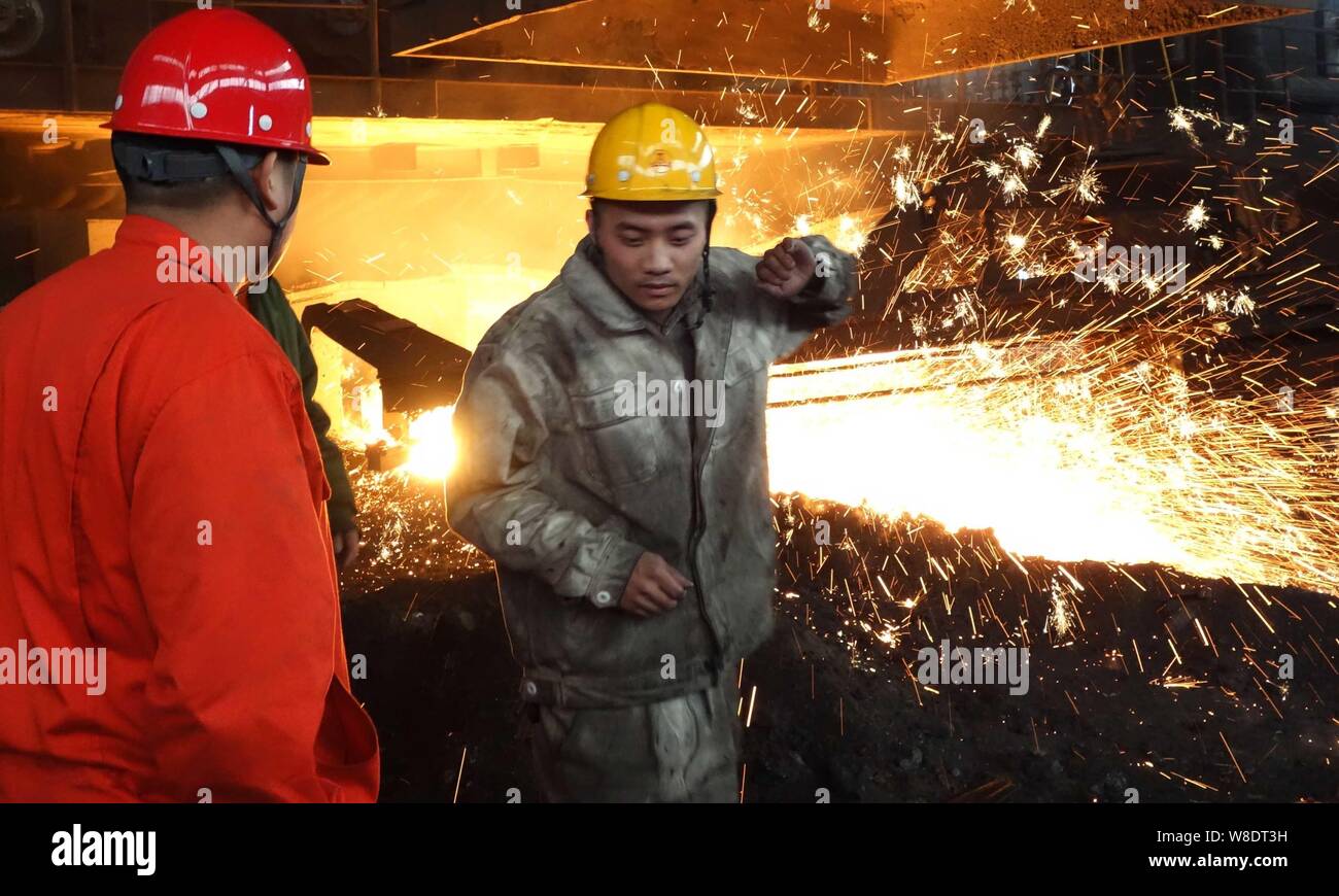 --FILE--Chinese workers survey the production of steel at a plant of ...
