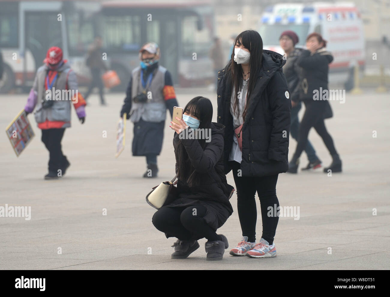 Tourists wearing face masks visit the Tiananmen Square in heavy smog in ...