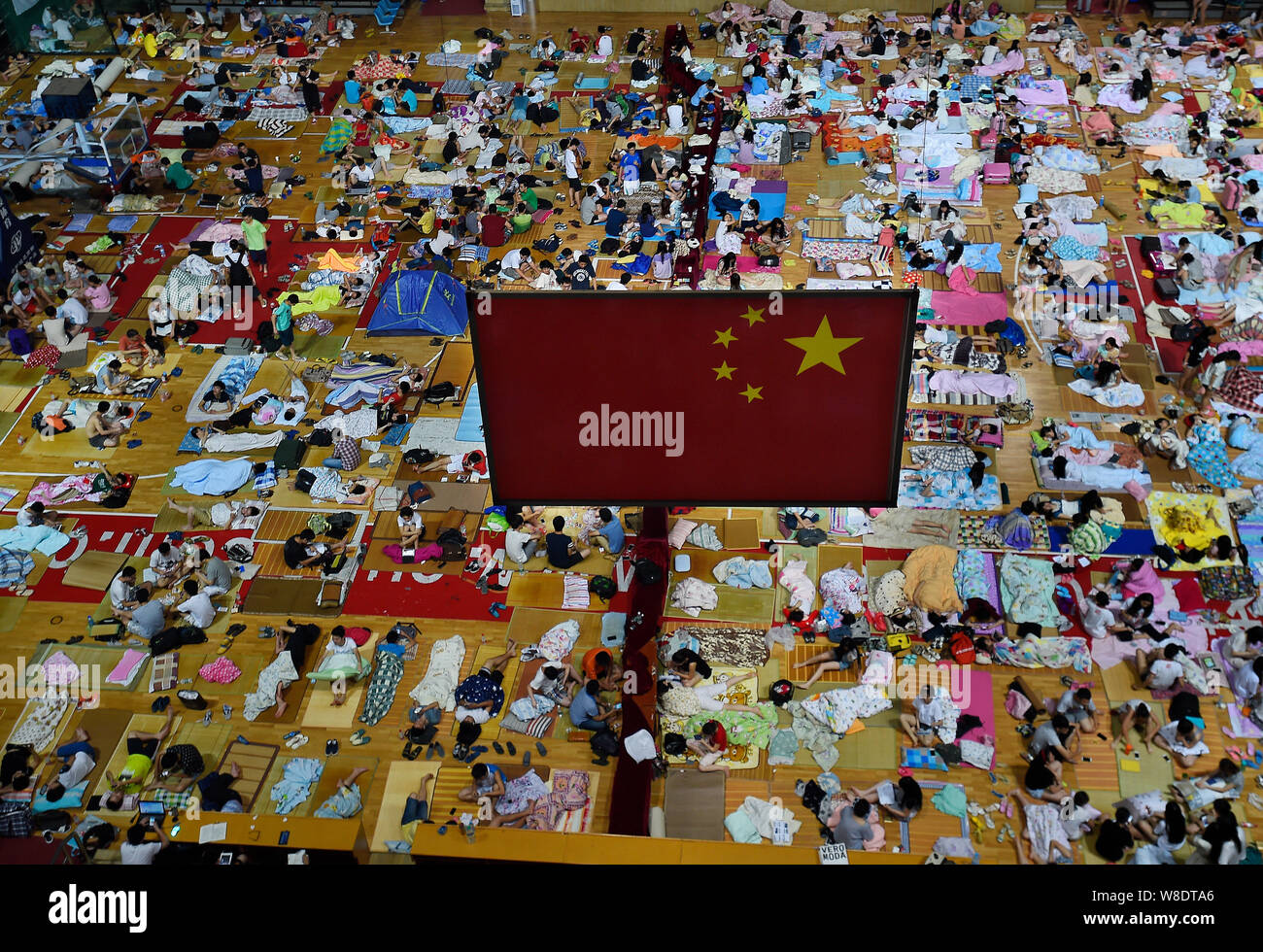 Students sleep on the floor in a gymnasium at Central China Normal ...