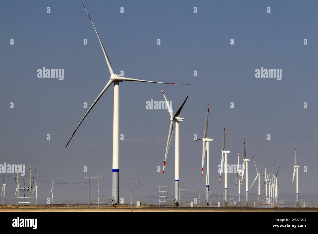 --FILE--Wind turbines whirl to generate electricity at a wind farm in ...