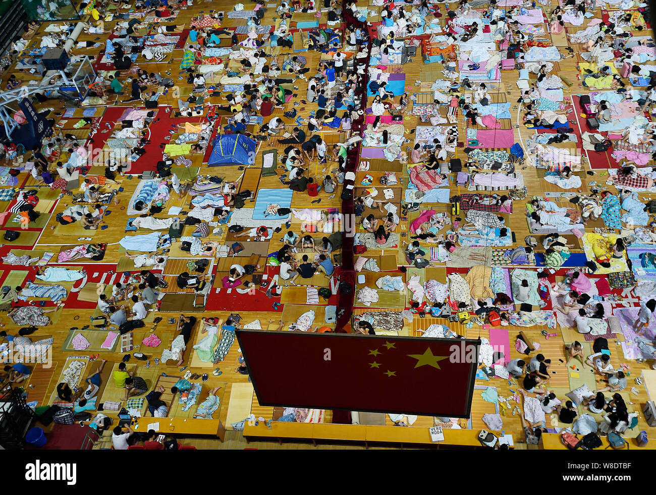 Students sleep on the floor in a gymnasium at Central China Normal ...