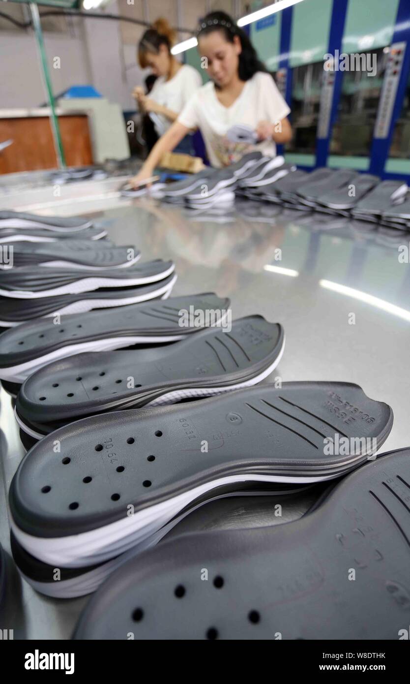 --FILE--Female Chinese workers make soles of sports shoes at a factory ...