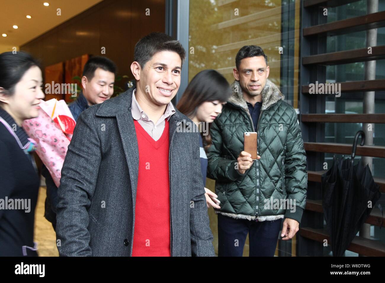 Argentine football star Dario Conca, front, poses as he exits the VIP ...