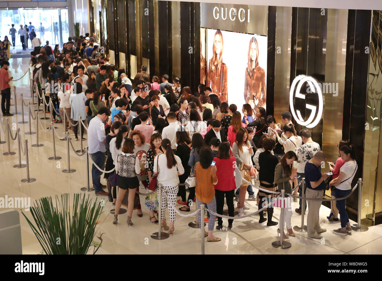 --FILE--Customers queue up outside a Gucci boutique of Kering SA at a ...