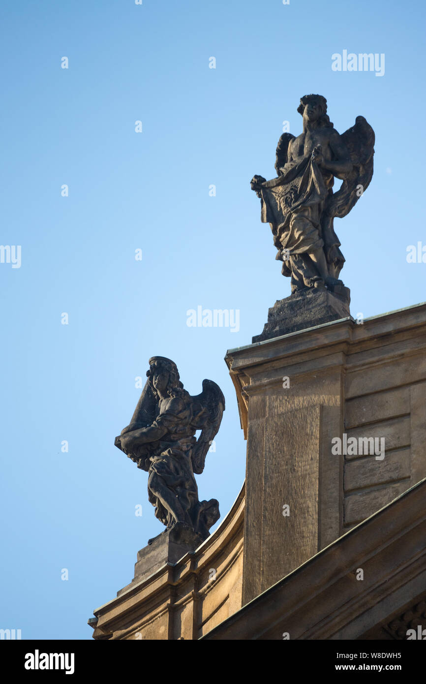 Statues on roof of St. Francis of Assisi church in Prague with blue sky ...