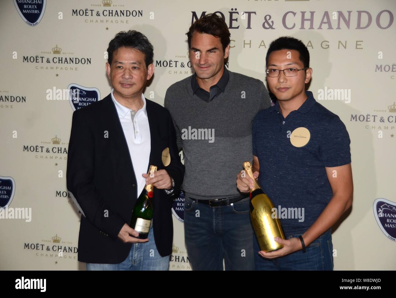 Swiss tennis star Roger Federer, center, poses at the welcome party for ...