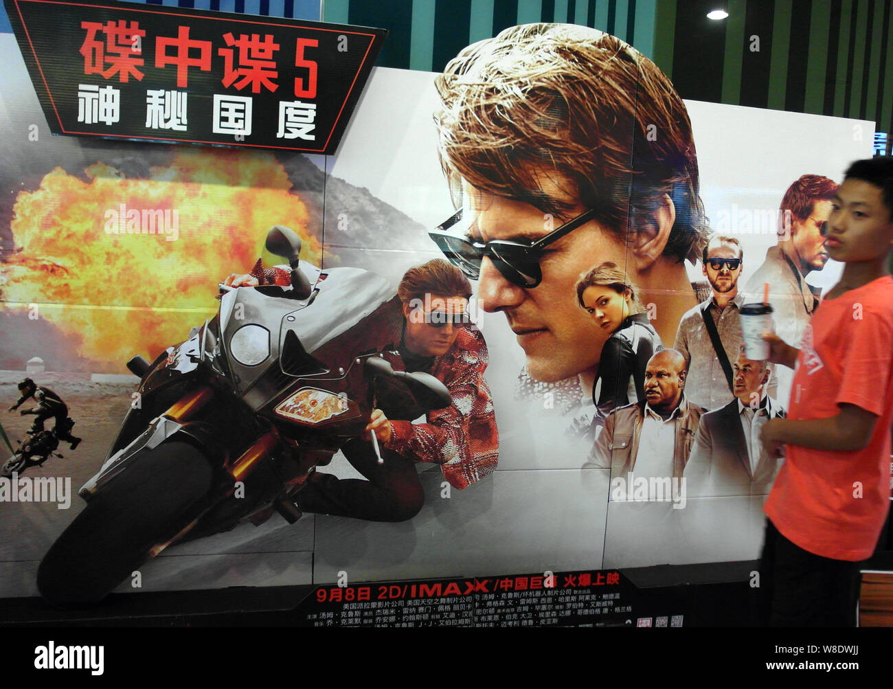 A Chinese filmgoer walks past a poster of the "Mission: Impossible ...
