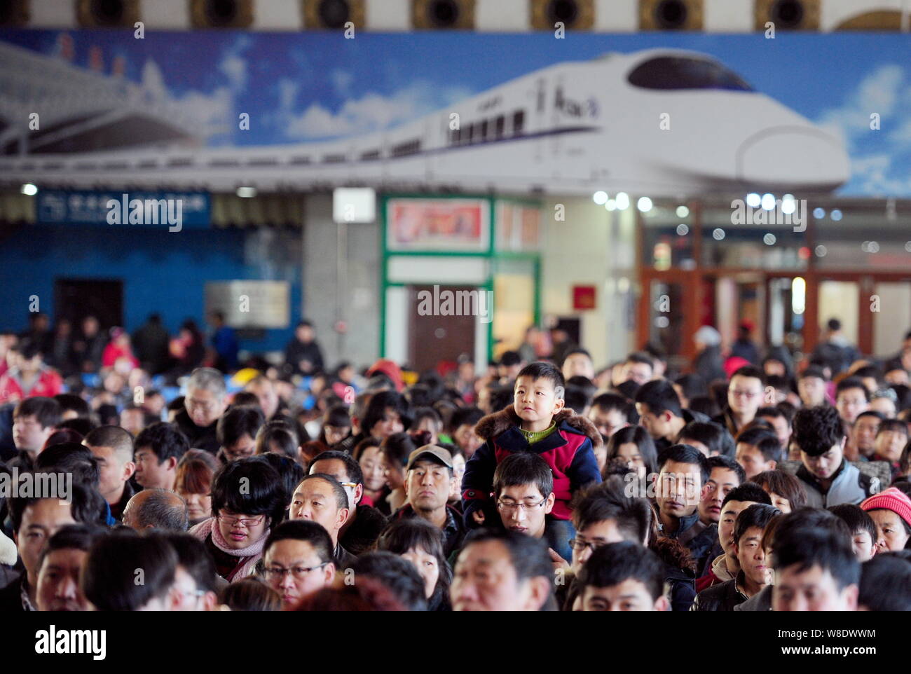 Chinese passengers crowd the Taiyuan Railway Station before going back ...