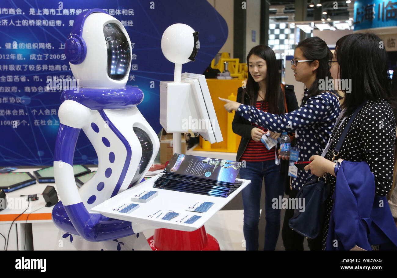 Visitors look at robots during the 3rd China (Shanghai) International ...