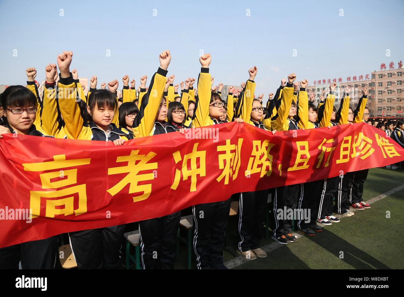 Young Chinese students chant slogans during a mass rally to prepare for ...