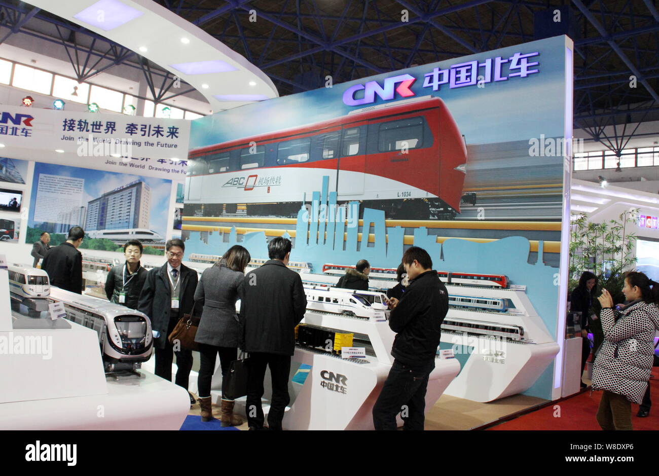 --FILE--Chinese visitors look at models of CRH (China Railway High ...