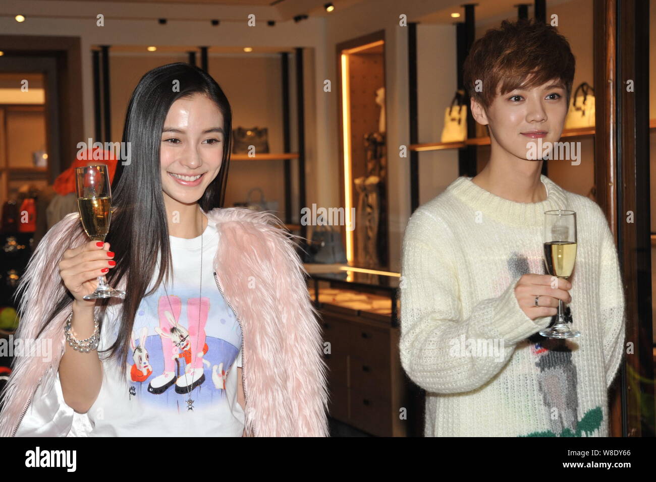 Hong Kong model and actress Angelababy, left, Chinese singer and actor Lu Han toast during the ...