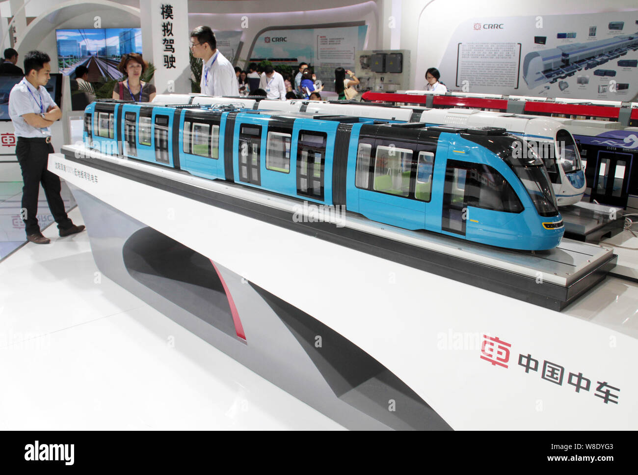 --FILE--Visitors look at model subway trains on display at the stand of ...