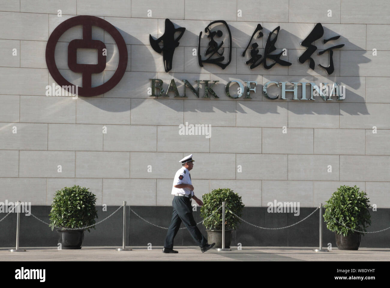 --FILE--A security guard walks past a logo of Bank of China (BOC) in ...