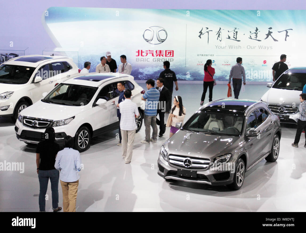--FILE--Visitors look at BAIC and Mercedes-Benz cars on display at the ...