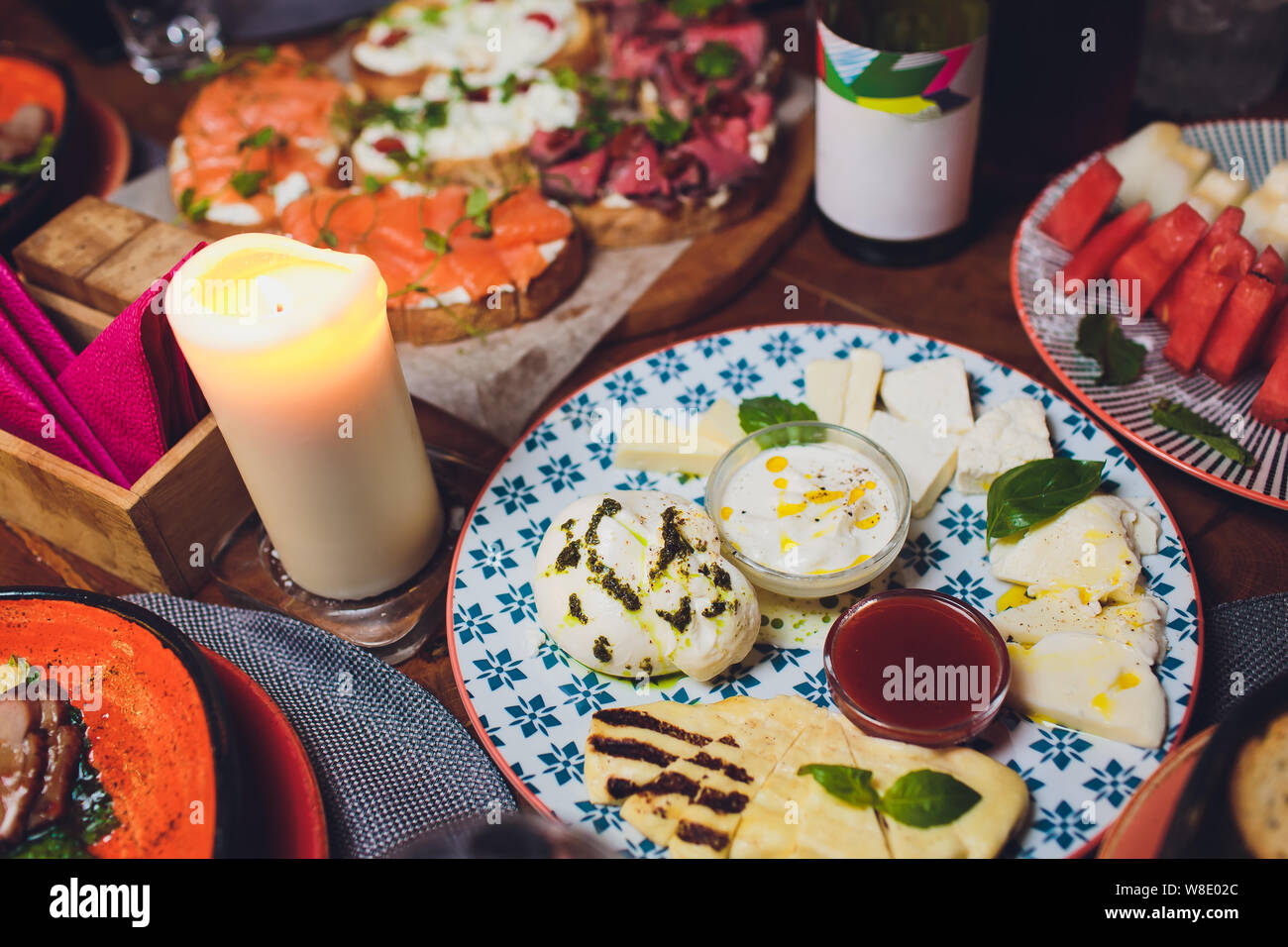Appetizers table with italian antipasti snacks and wine in glasses ...