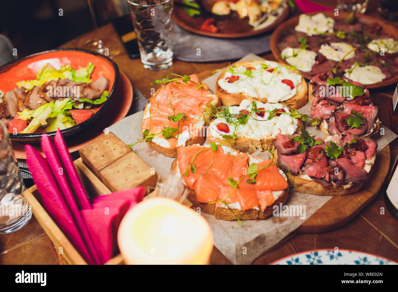 Appetizers table with italian antipasti snacks and wine in glasses ...