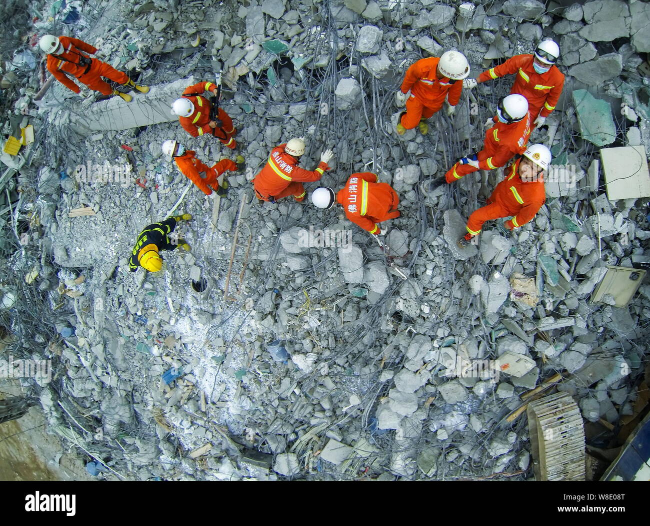 In this aerial view from a drone, Chinese rescuers search for survivors ...