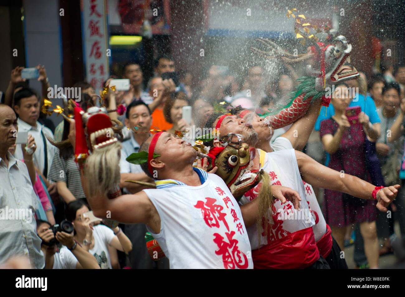 Performers spray beer from their mouths to perform a drunken dragon ...