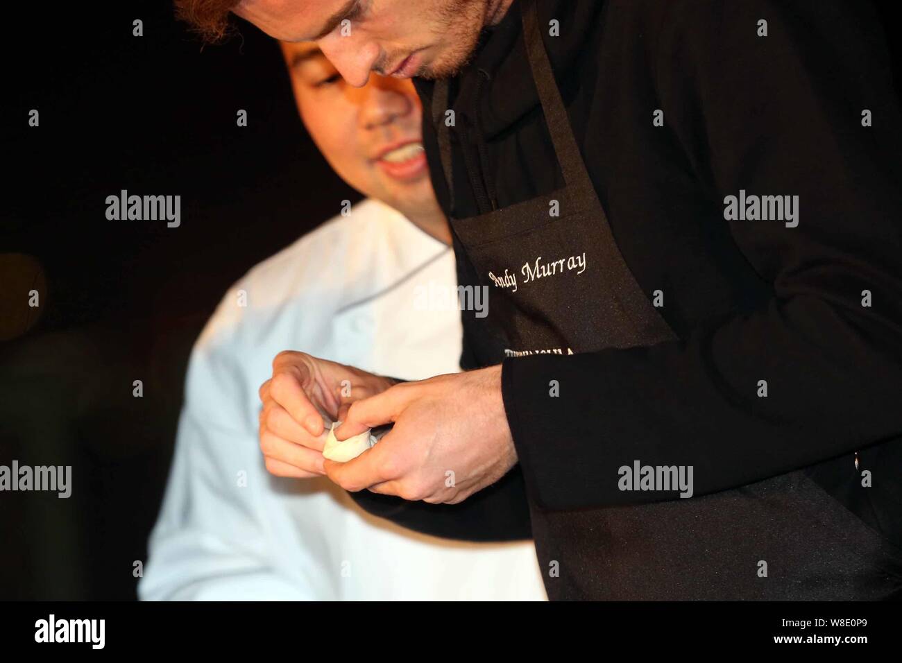 British tennis player Andy Murray, right, learns making dumplings from ...