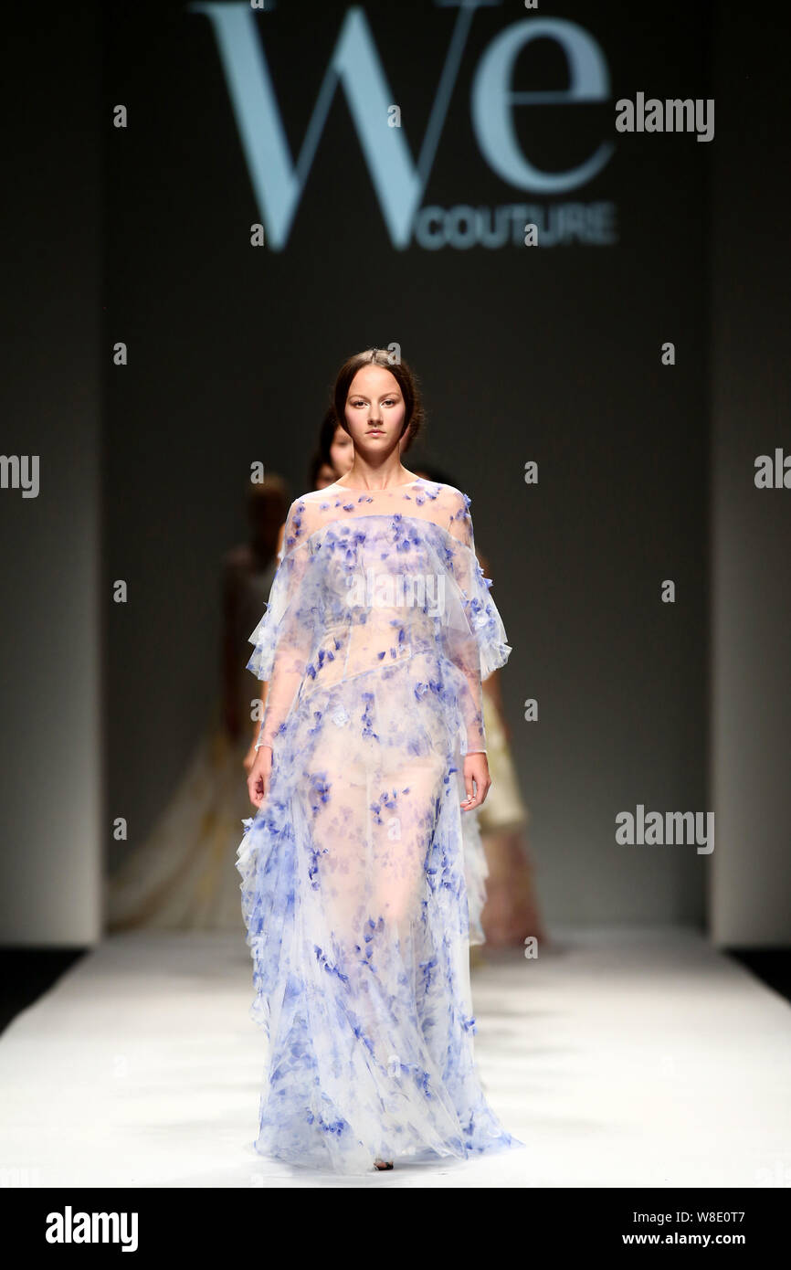 A model displays a new creation at the fashion show of Chinese wedding dress brand We Couture ...