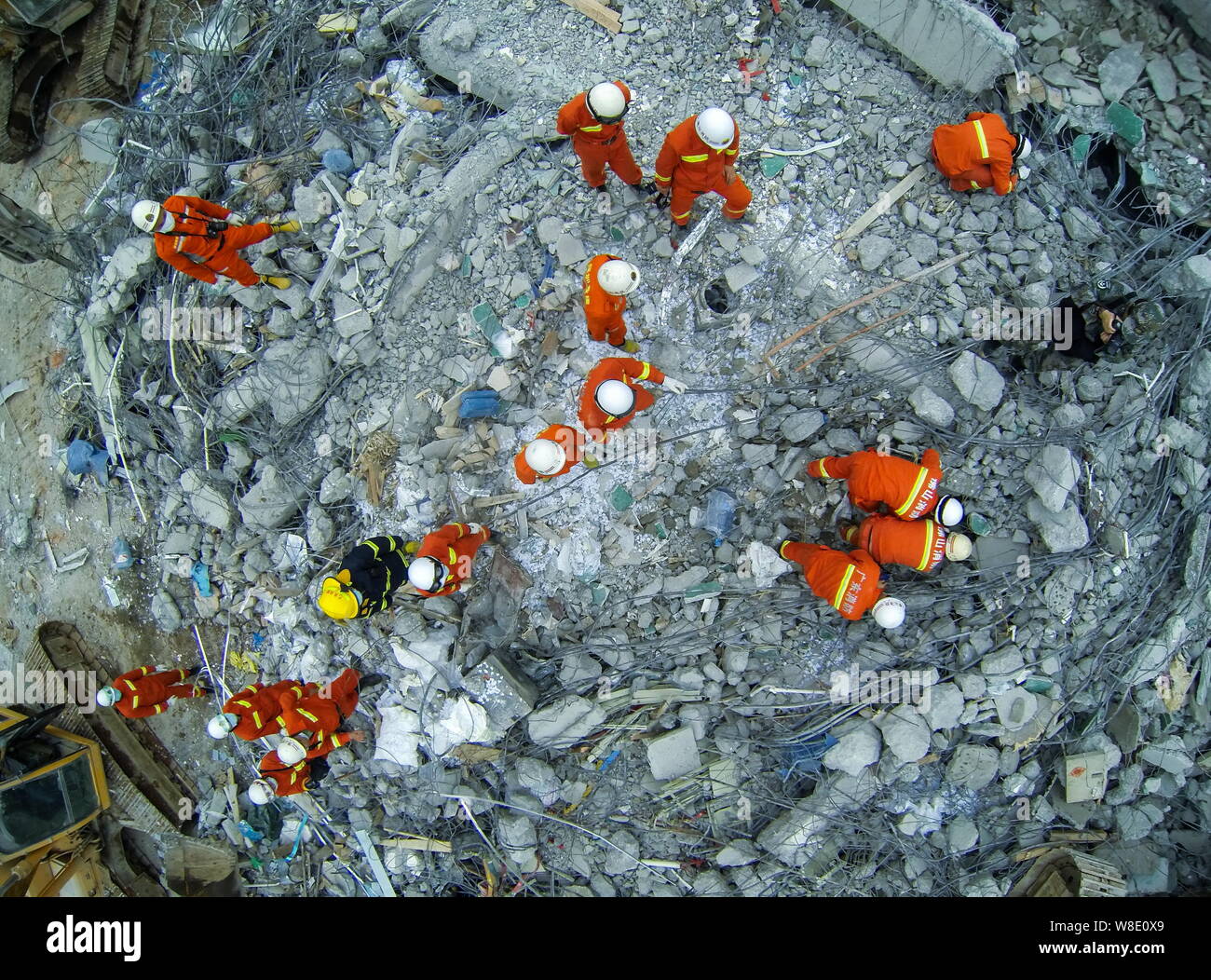 In this aerial view from a drone, Chinese rescuers search for survivors ...