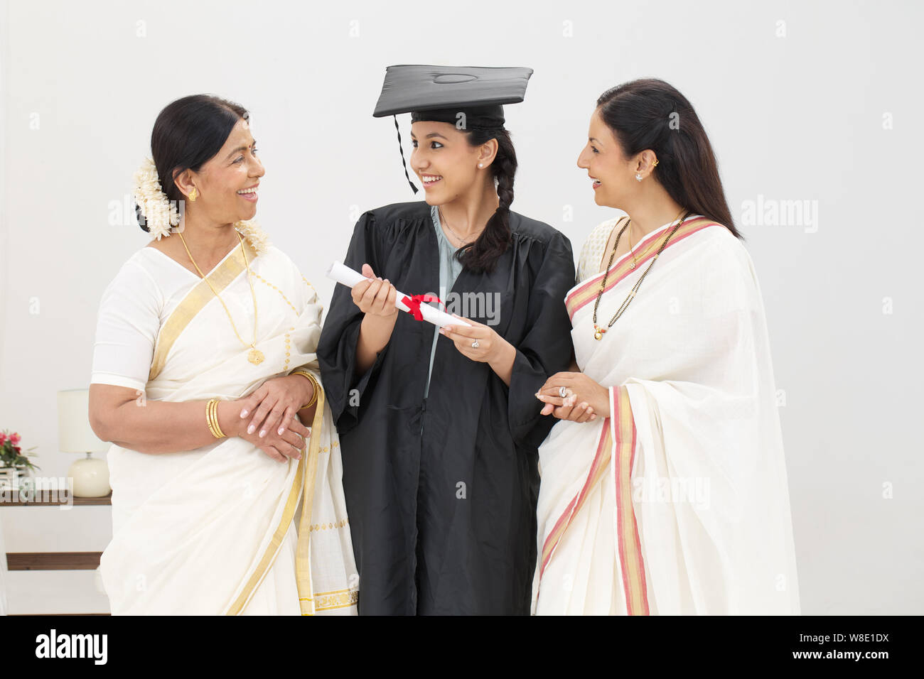 Graduate student standing with her parents and smiling Stock Photo - Alamy