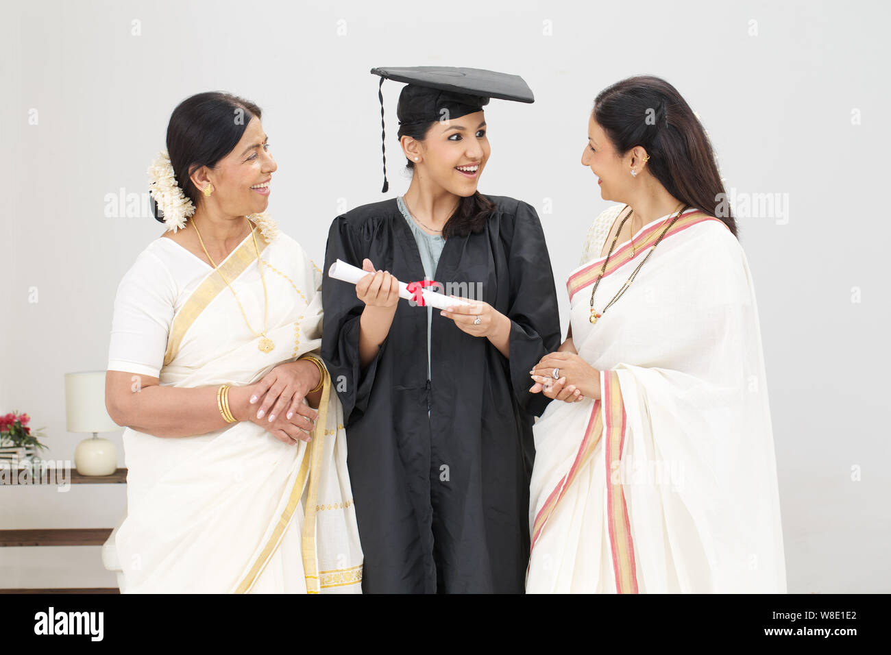 Graduate student standing with her parents and smiling Stock Photo - Alamy