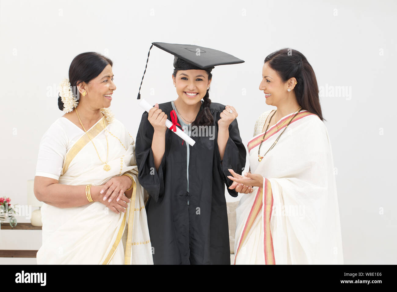 Graduate student standing with her parents and smiling Stock Photo - Alamy