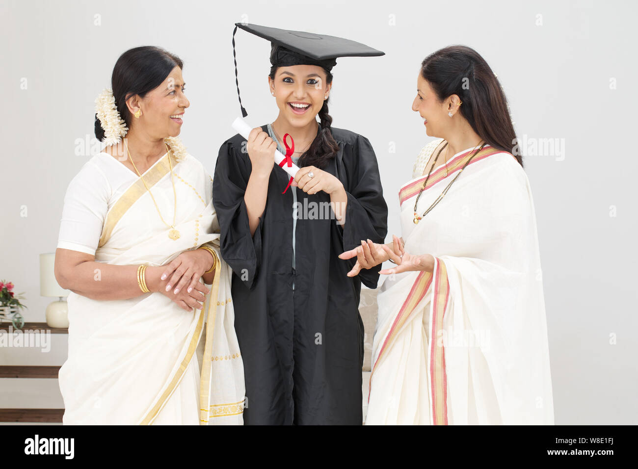 Graduate student standing with her parents and smiling Stock Photo - Alamy