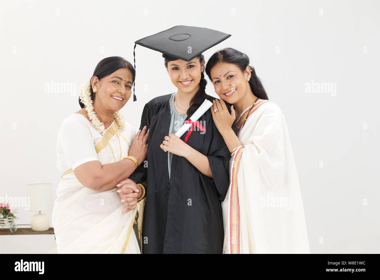 Graduate student standing with her parents and smiling Stock Photo - Alamy