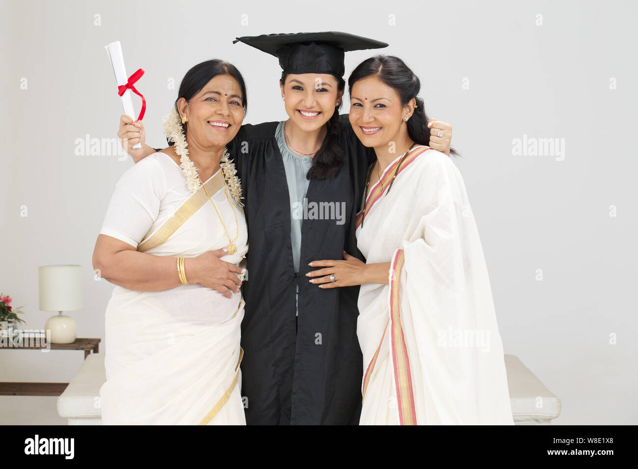 Graduate student standing with her parents and smiling Stock Photo - Alamy