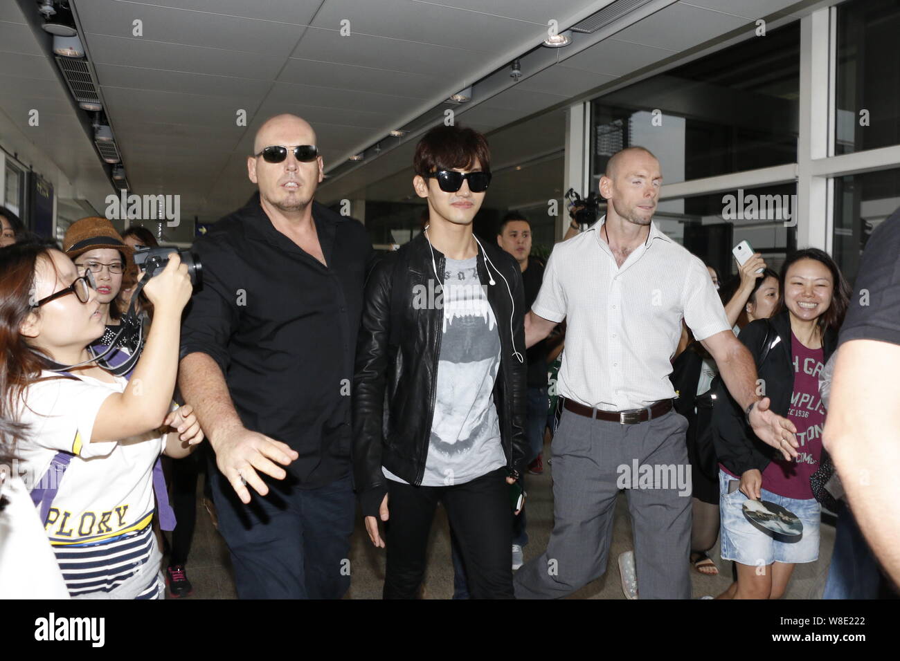 Singer and actor Shim Chang-min, center, also known by his stage name ...