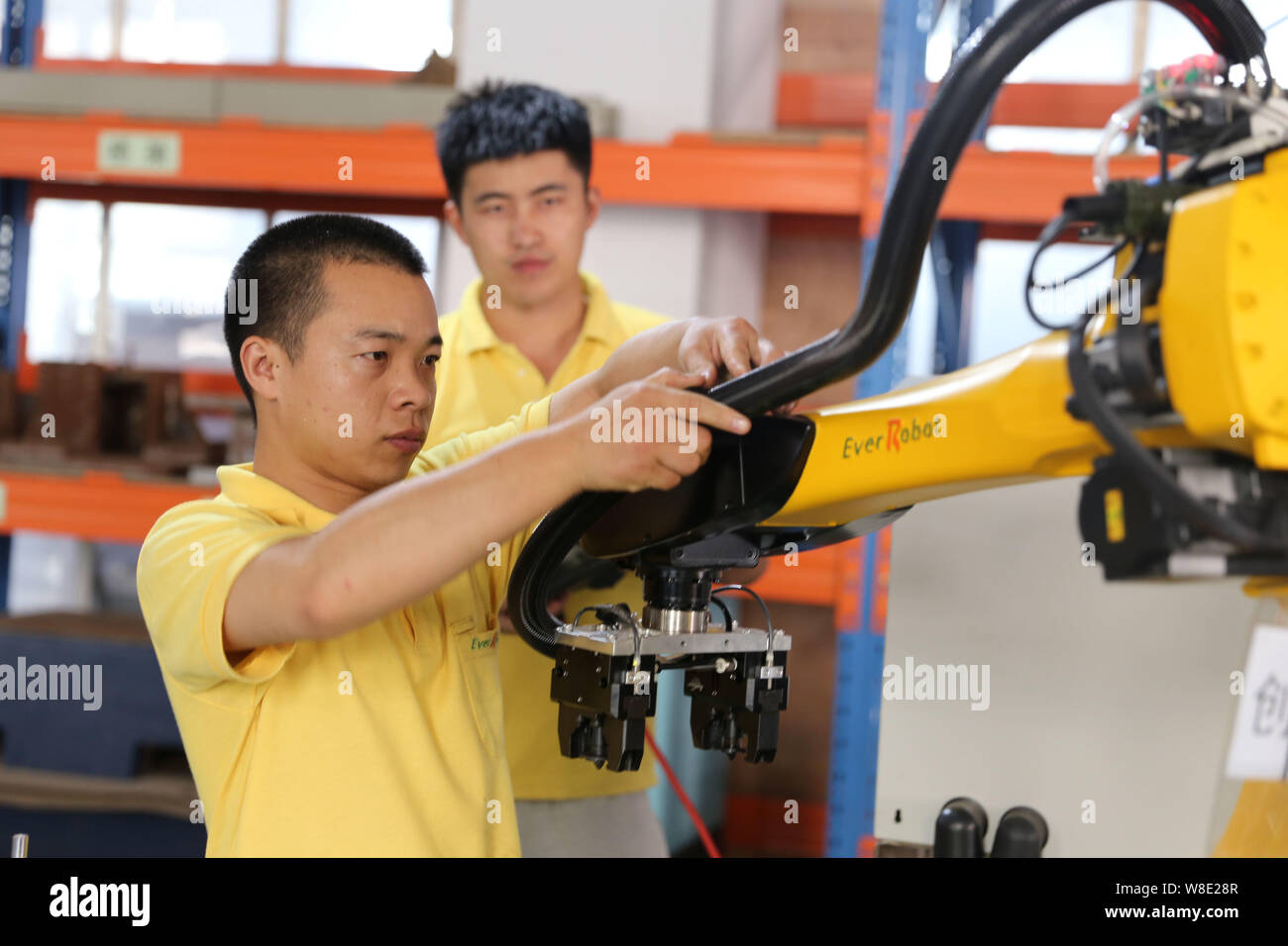 --FILE--Chinese workers test robot arms at the plant of Zhejiang ...