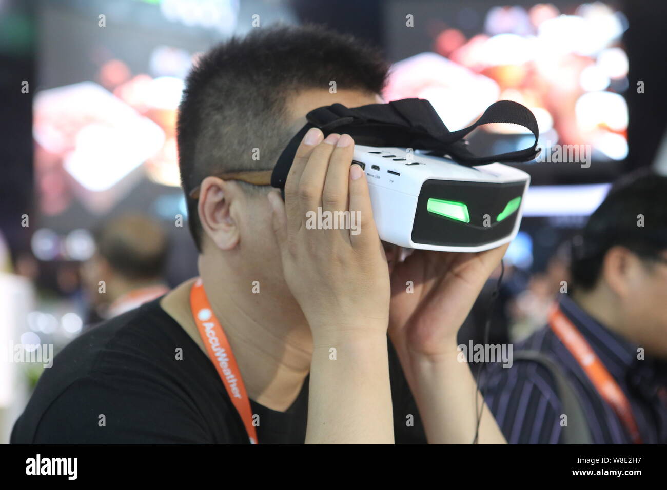 A visitor tries out a wearable 3D video player device during the ...