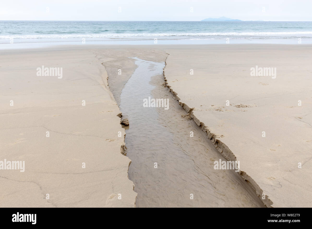 The water flows on the sand. Coastal erosion water Stock Photo - Alamy