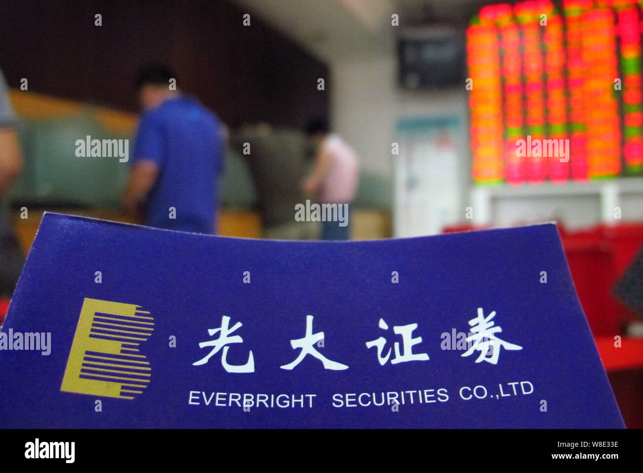 --FILE--A pamphlet of Everbright Securities is shown at a stock ...