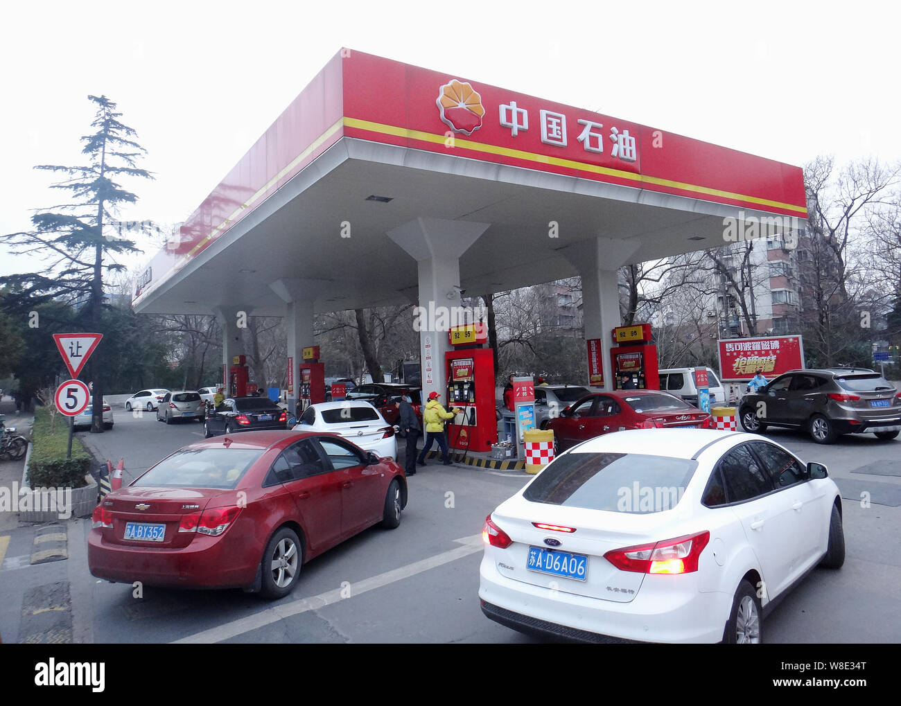 --FILE--Cars queue up to be refueled at a gas station of PetroChina, a ...