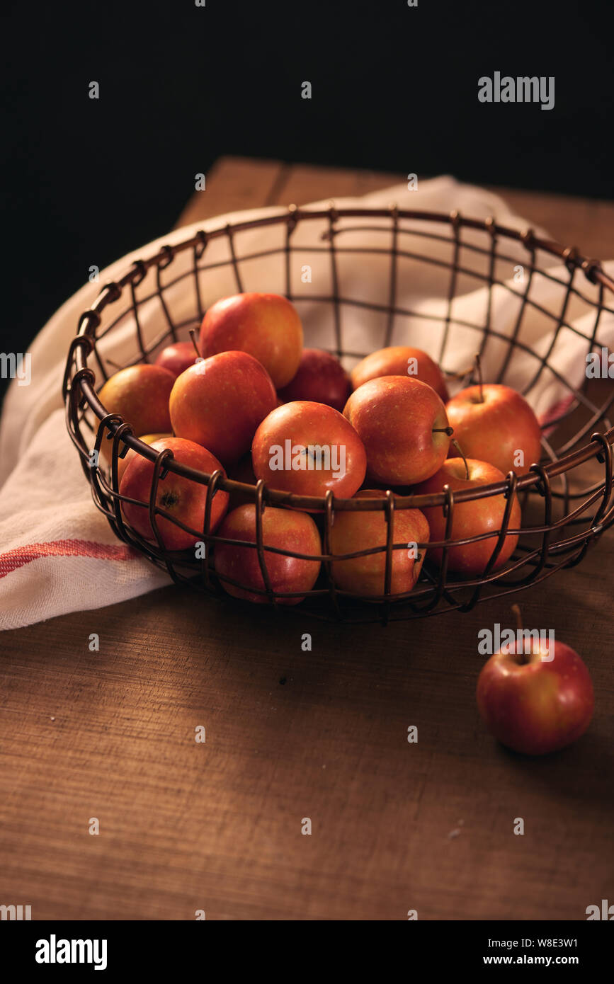 Sweet mini apples in a basket ready for eat over black background Stock ...